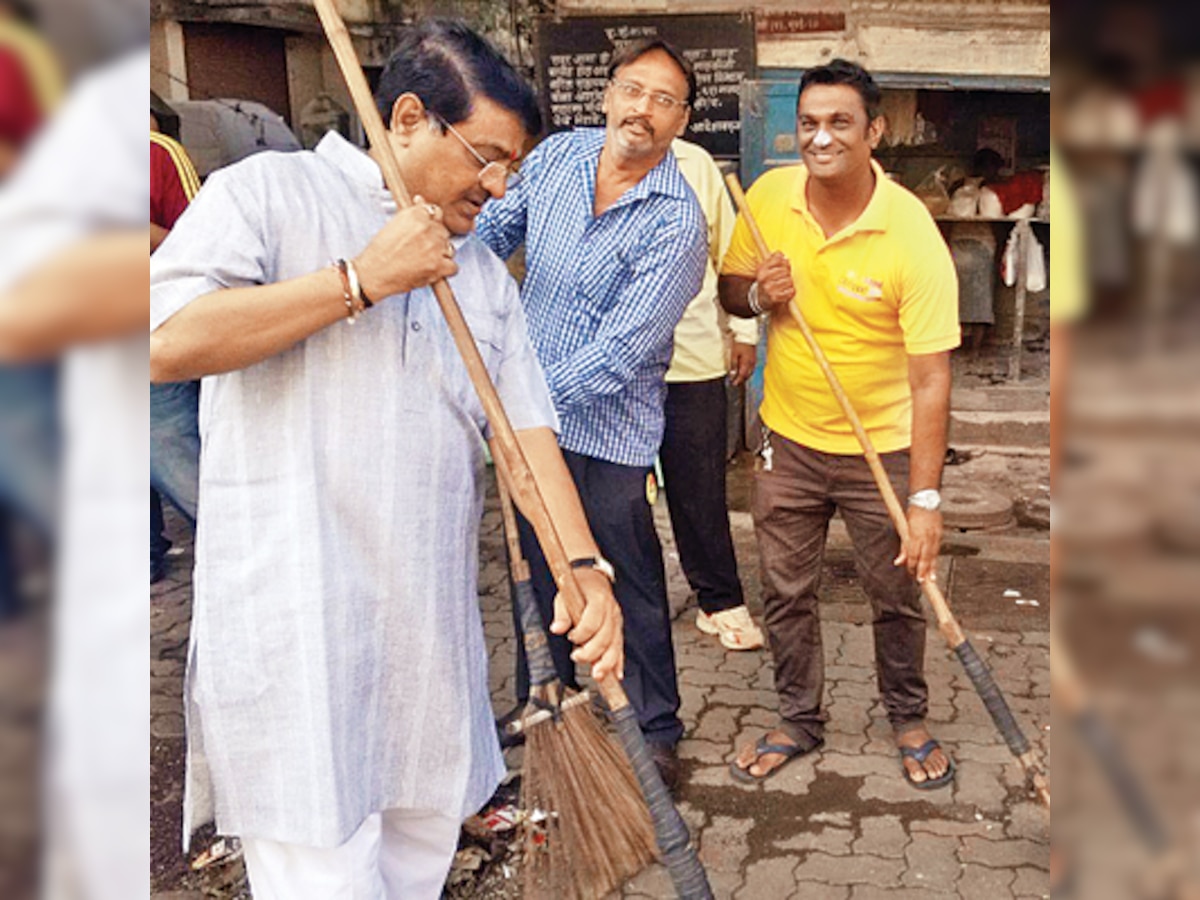 BJP neta poses with broom for lensmen