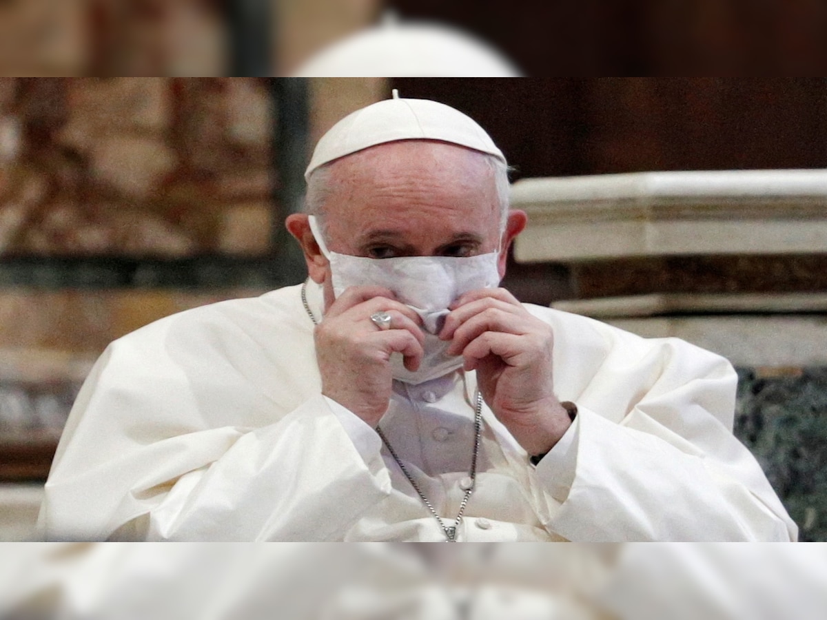 Pope Francis wears mask for first time at public service