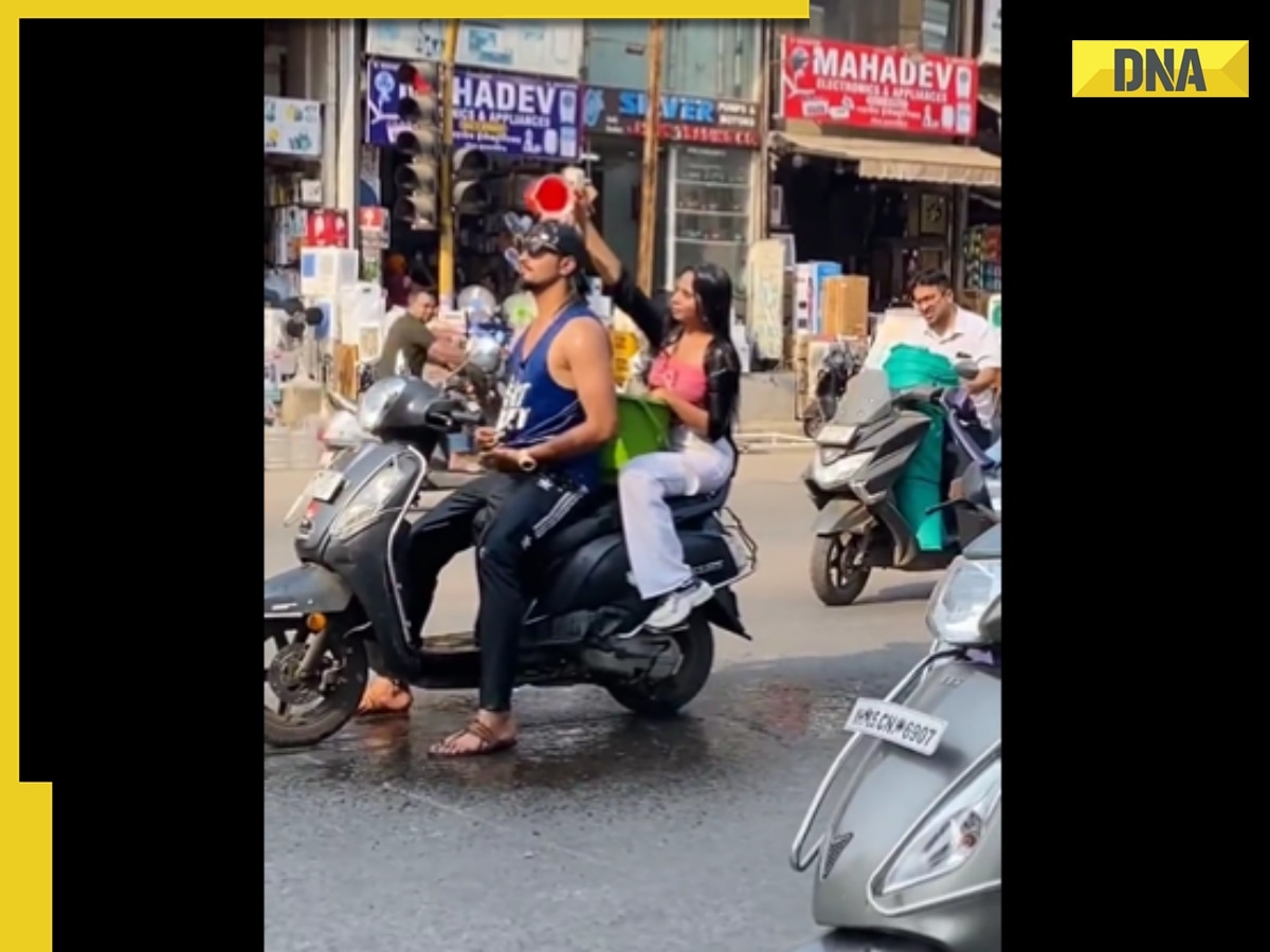 Viral video: Couple takes 'bath' while riding scooty in Maharashtra, netizens say 'famous hone ...