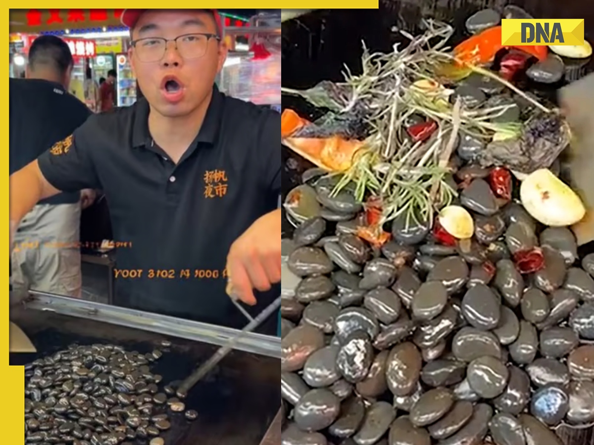 Chinese street vendor sells stir-fried pebbles with chilli and garlic ...
