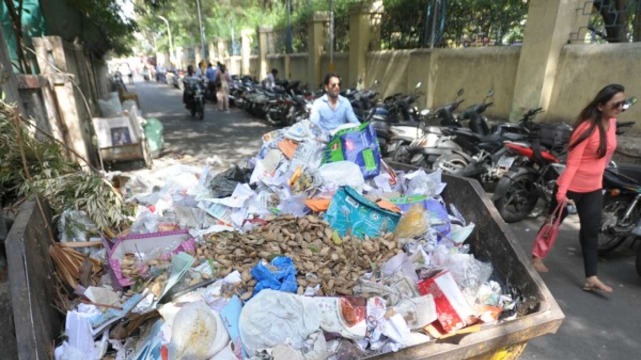 Overflowing garbage bins leave city stinking in monsoon