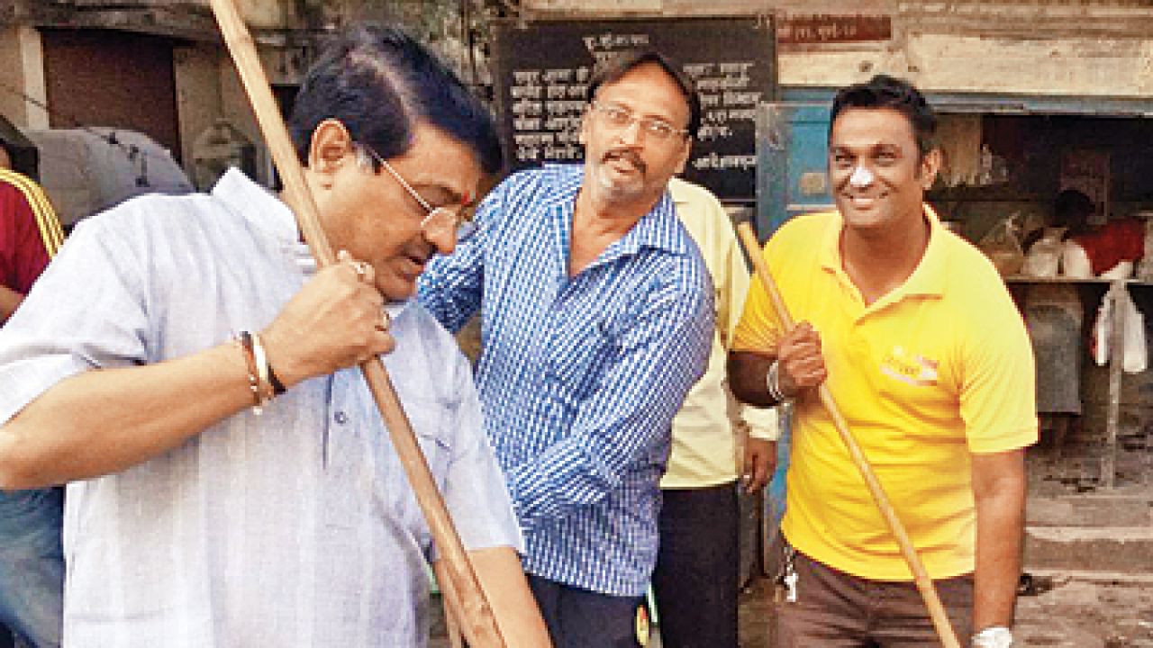 BJP neta poses with broom for lensmen