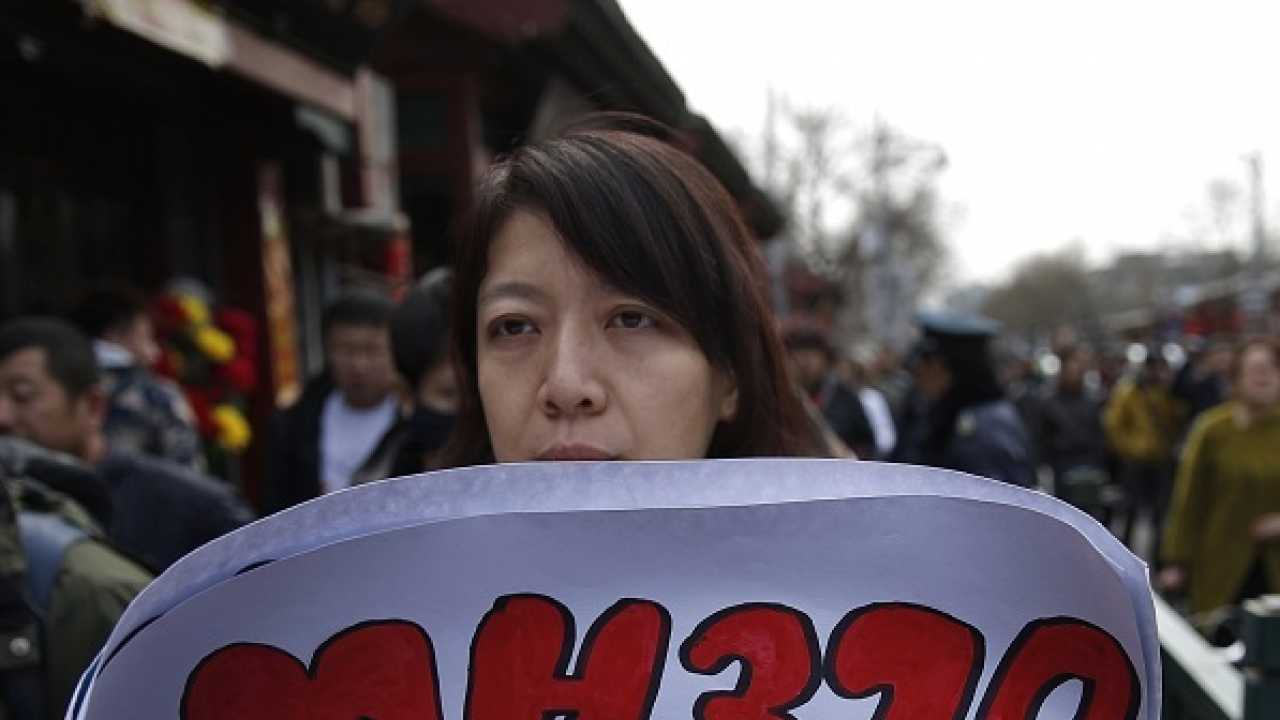 Chinese relatives mark MH370 anniversary under police gaze