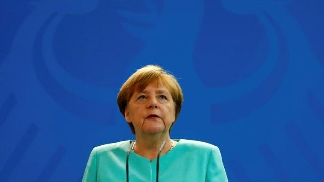 A year after height of refugee crisis, Angela Merkel's party dips in poll