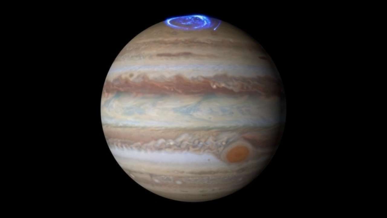 NASA probe beams back image of Jupiter's swirling clouds