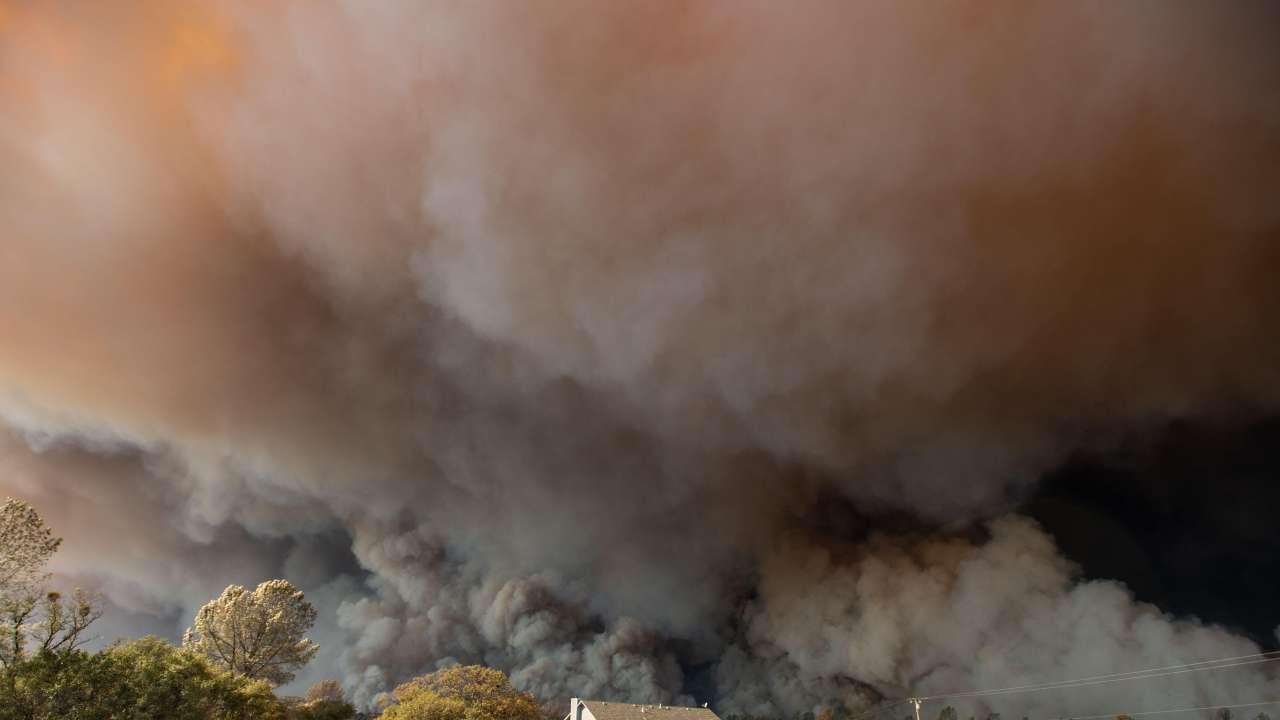 California wildfire evacuees prepare their tents for heavy rains