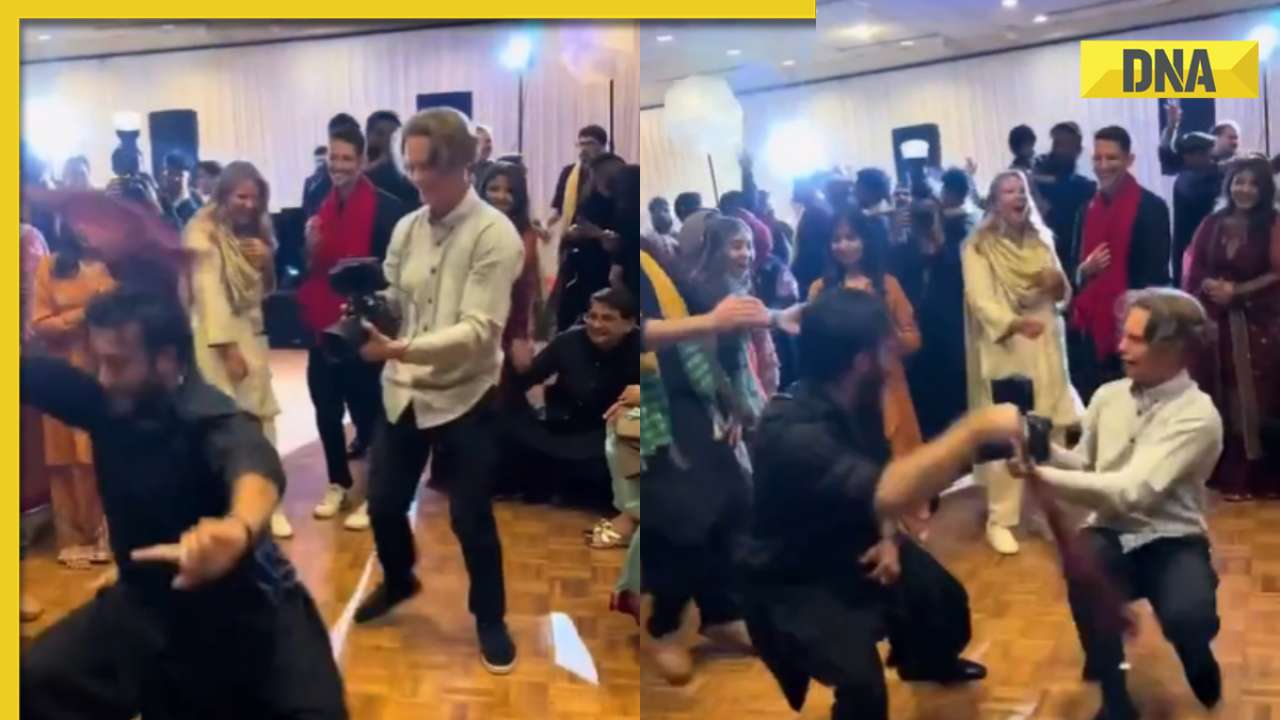 Camera in one hand, groove in other: Photographer steals the show at ...