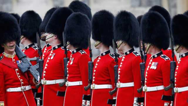UK's royal guards move behind metal fences on attack fears