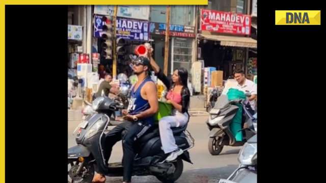 Viral video: Couple takes 'bath' while riding scooty in Maharashtra, netizens say 'famous hone ...